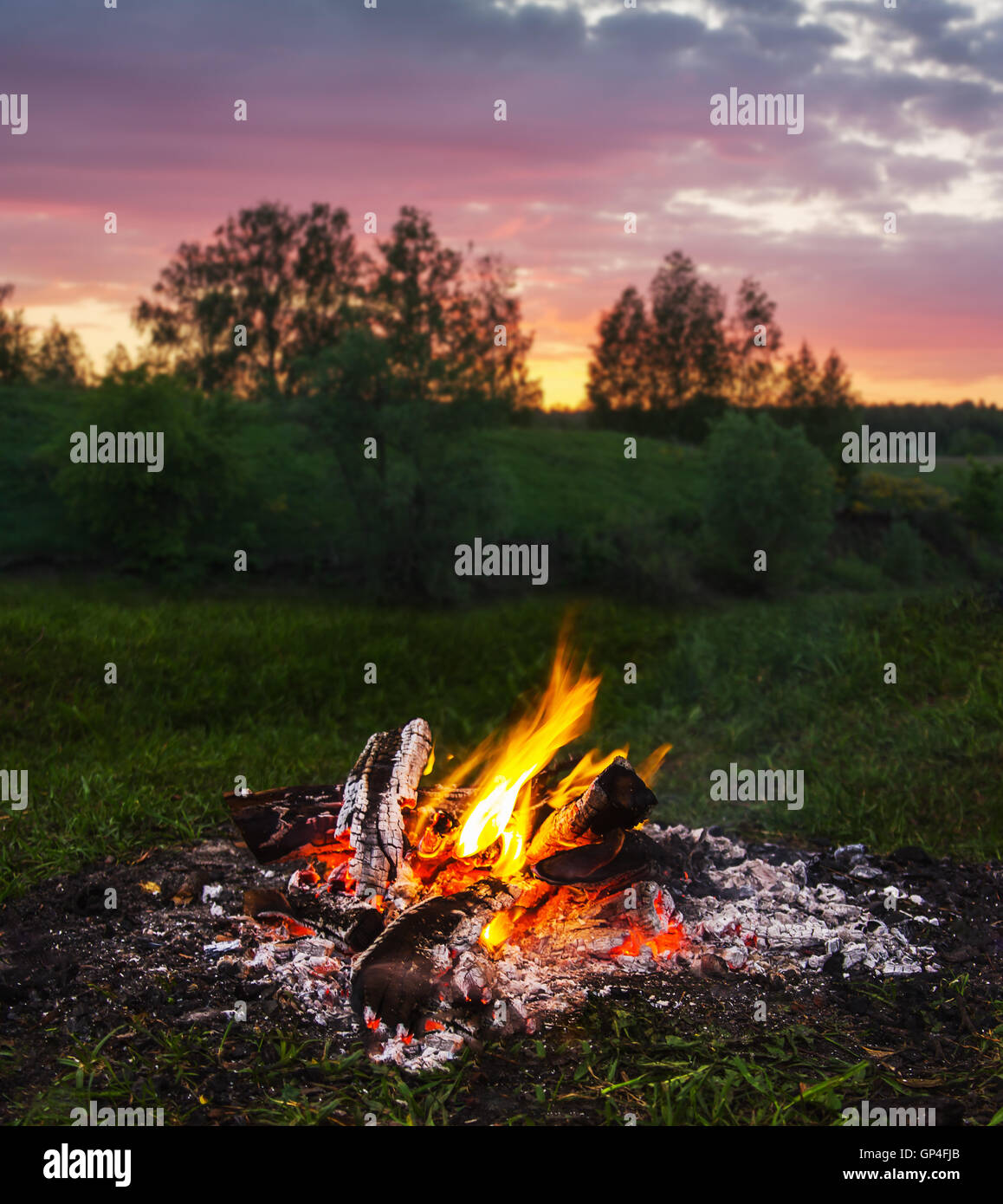 Fireplace in forest at dusk Stock Photo - Alamy