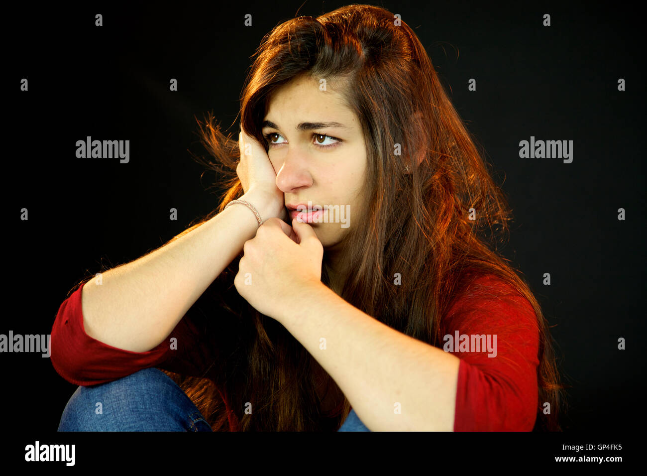 Sad woman almost crying alone in the dark Stock Photo - Alamy
