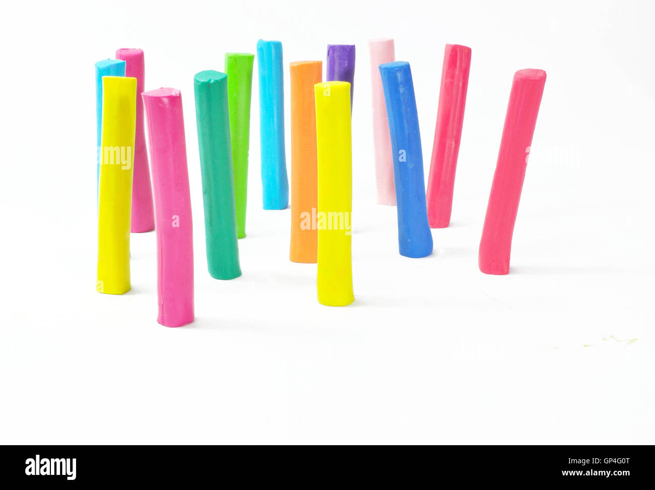 Colorful plasticine stick stand on white background Stock Photo - Alamy