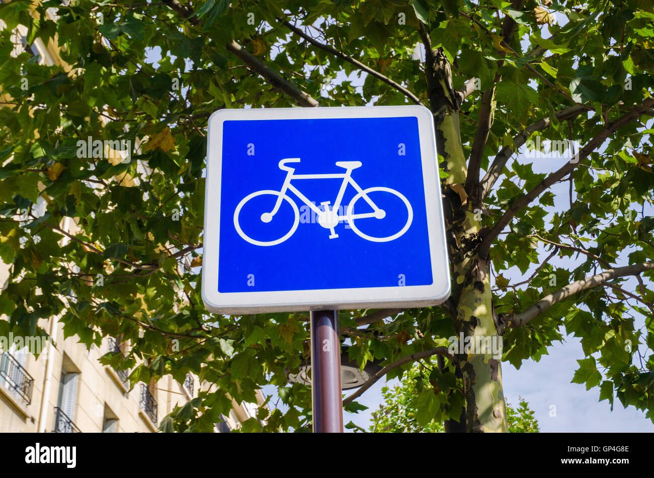 Bicycle sign on blue background Stock Photo - Alamy