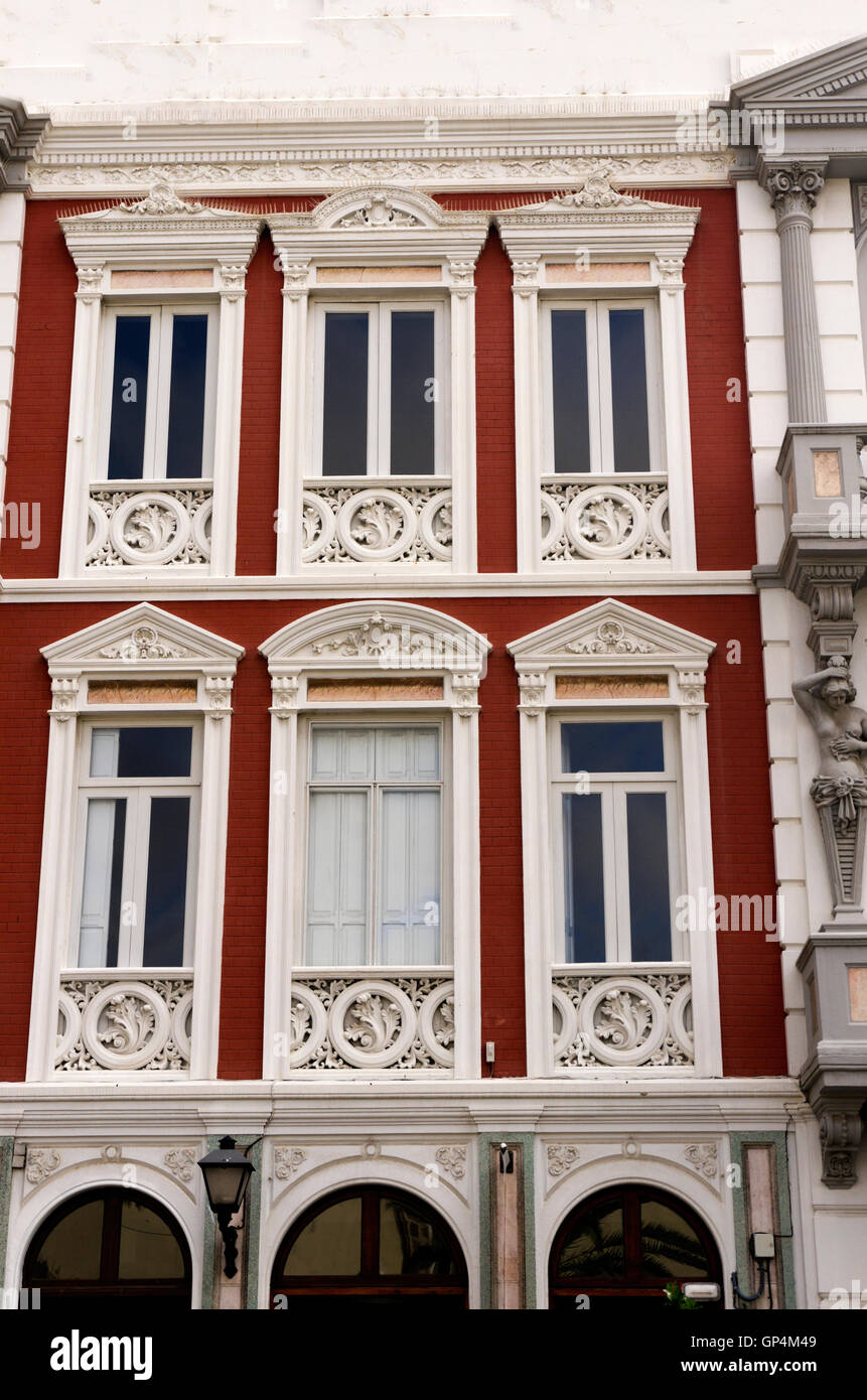 Marble frames set in upper floors of dark pink house hi-res stock ...