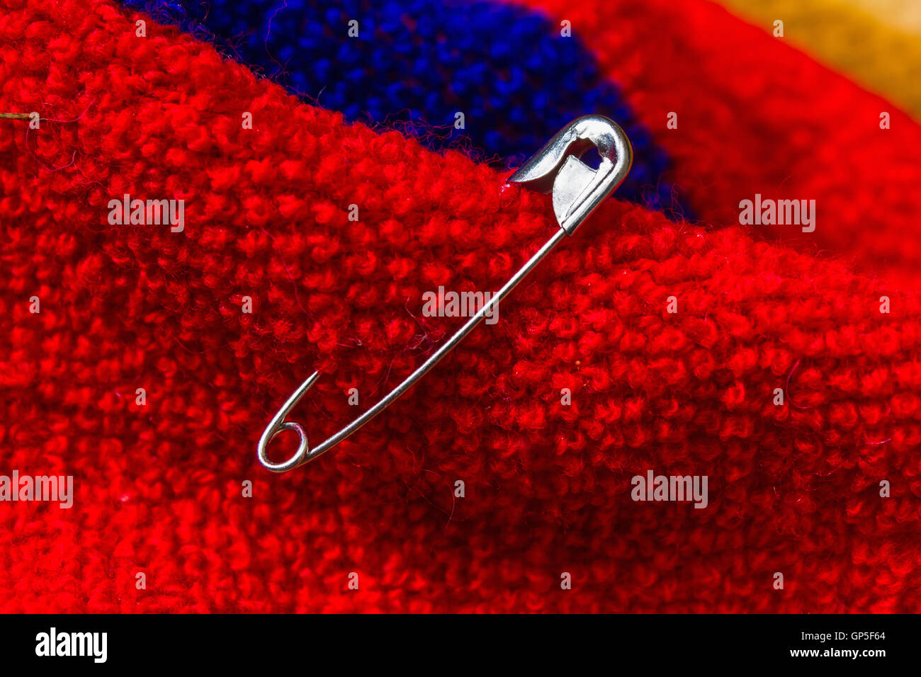 Safety pin pinned to the texture fabric Stock Photo - Alamy