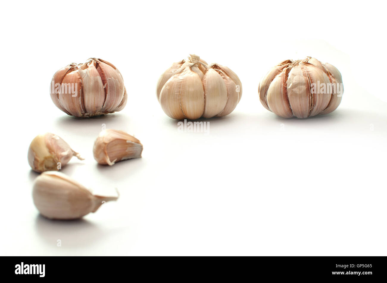 Garlic bulbs in three positions, isolated on white Stock Photo - Alamy