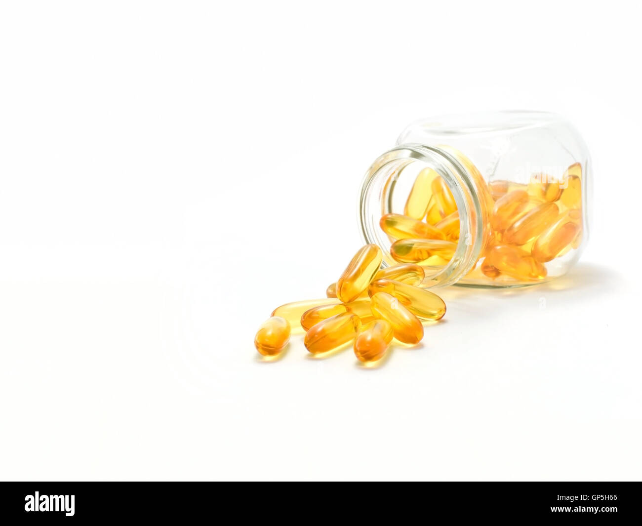 Spilled Fish oil capsules and container Stock Photo - Alamy