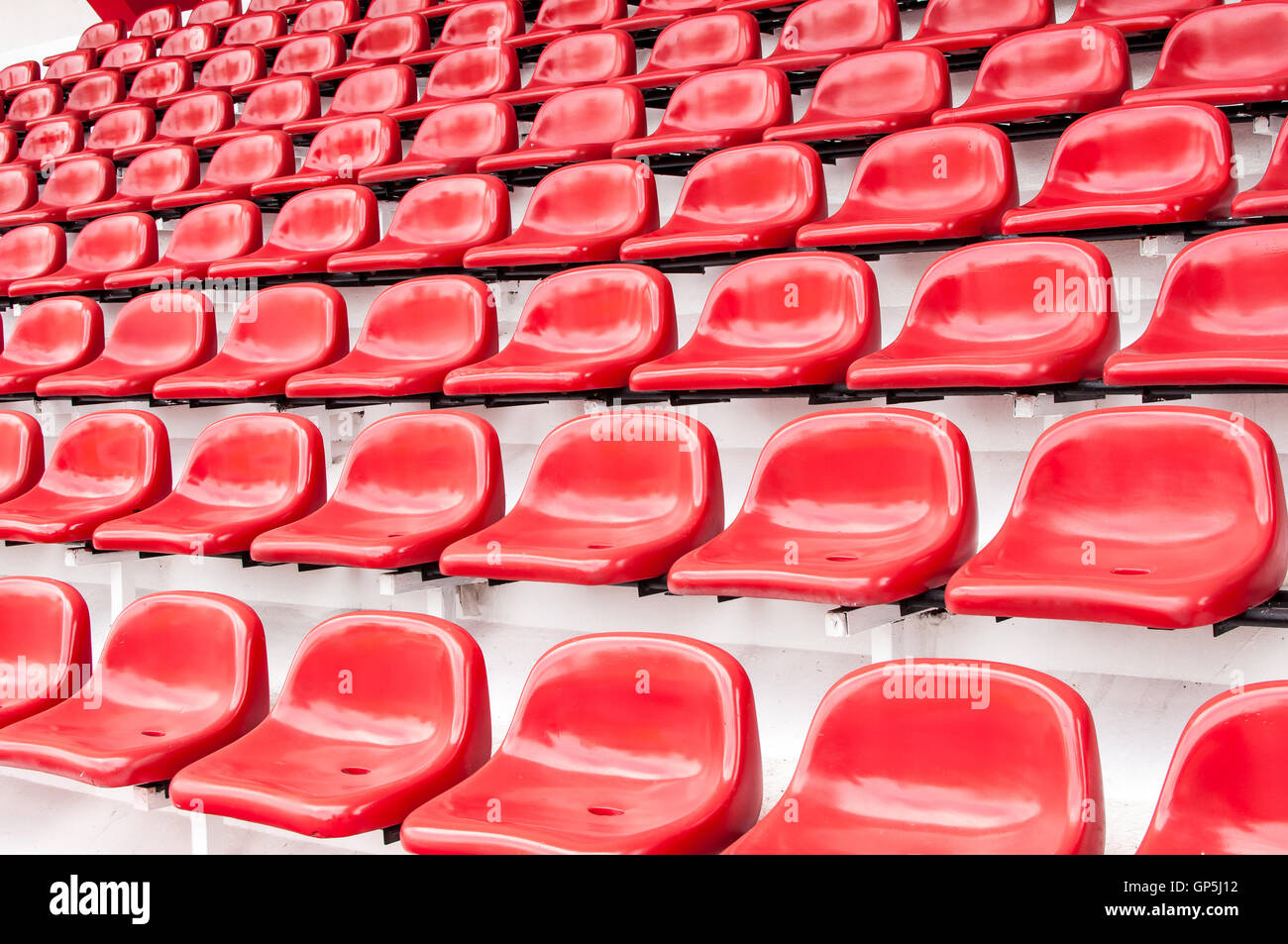 Bright red stadium seats Stock Photo - Alamy