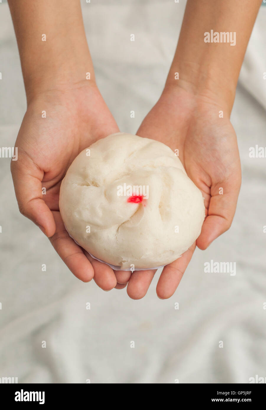 Hand giving a bun Stock Photo - Alamy