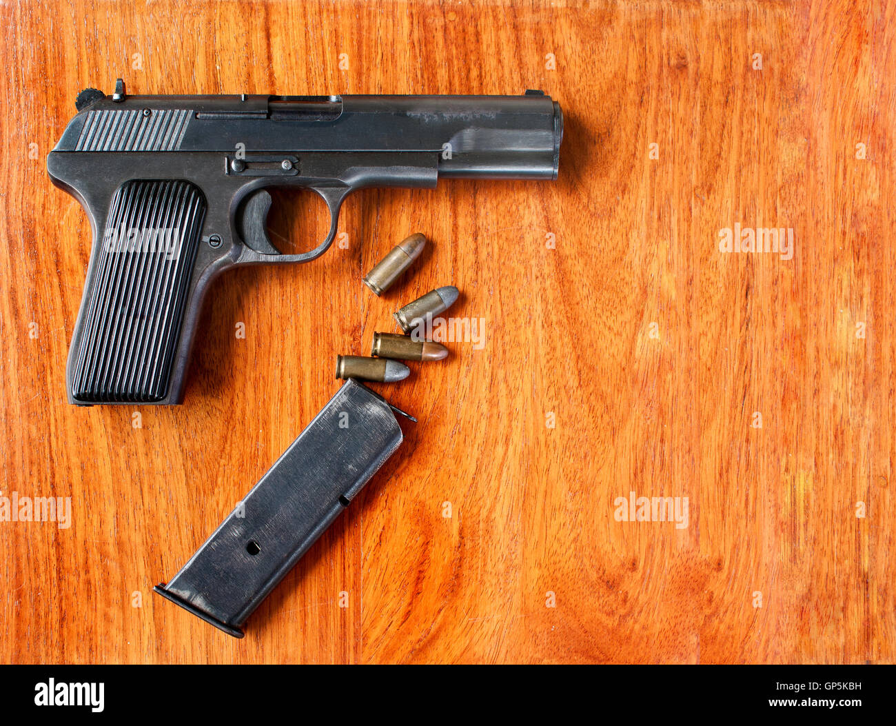 Black gun on brown table hi-res stock photography and images - Alamy