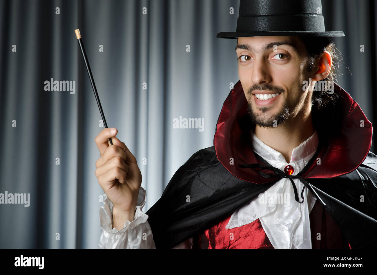 Magician doing tricks on white Stock Photo - Alamy