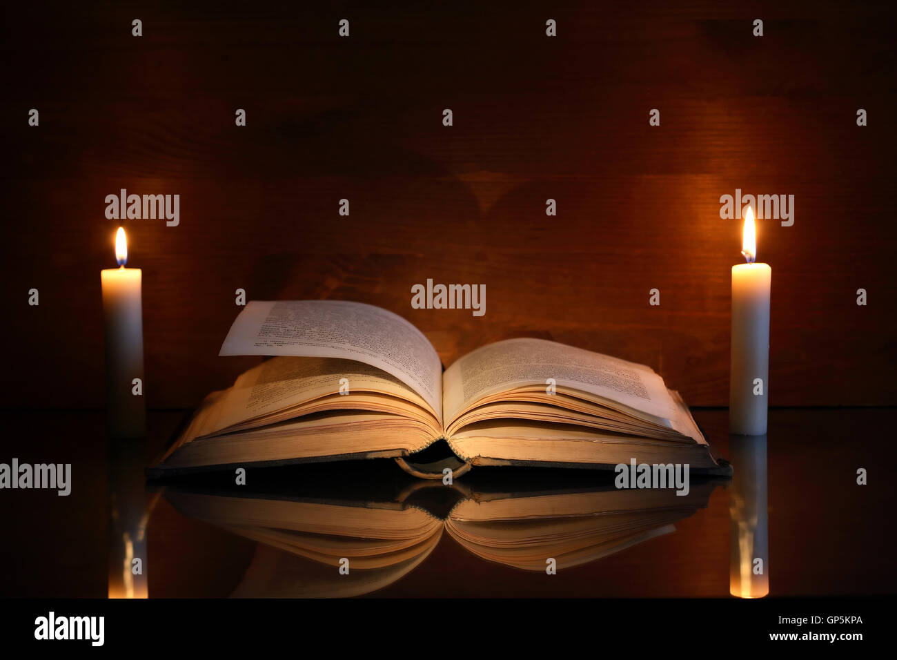 Book And Candles Stock Photo - Alamy