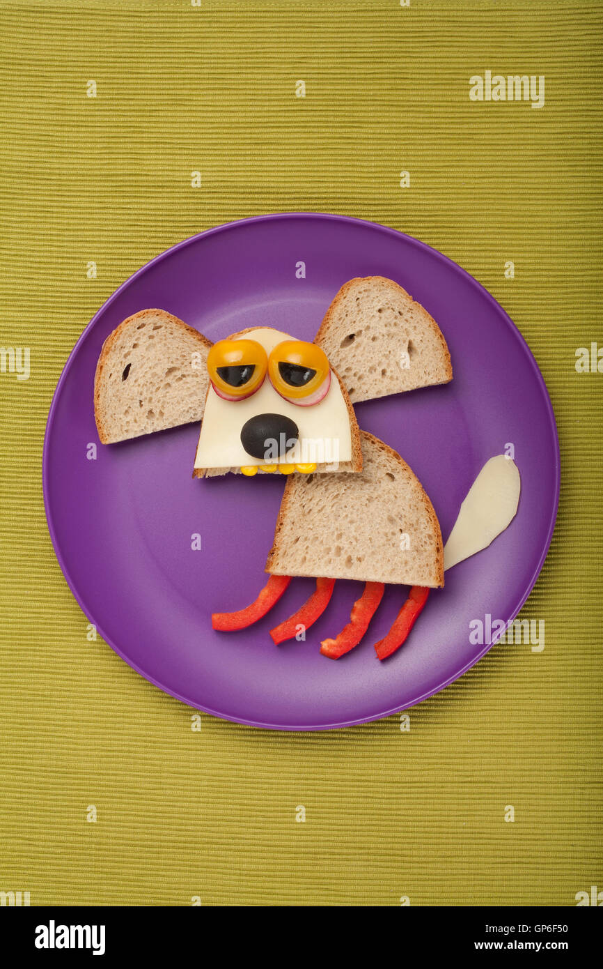 Dog made of bread and vegetables on plate and fabric Stock Photo - Alamy