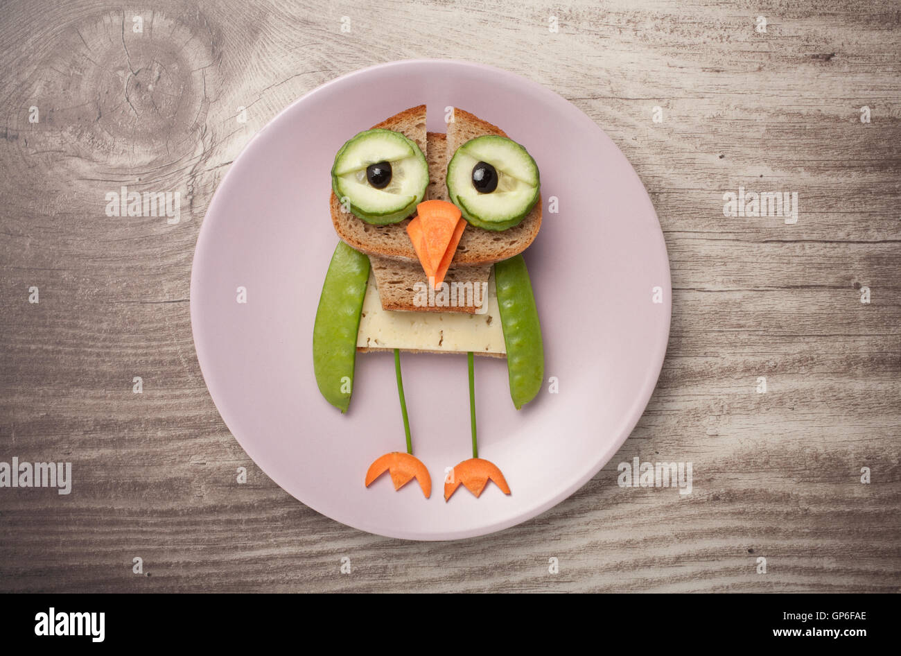 Owl made of bread and vegetables on plate and desk Stock Photo - Alamy