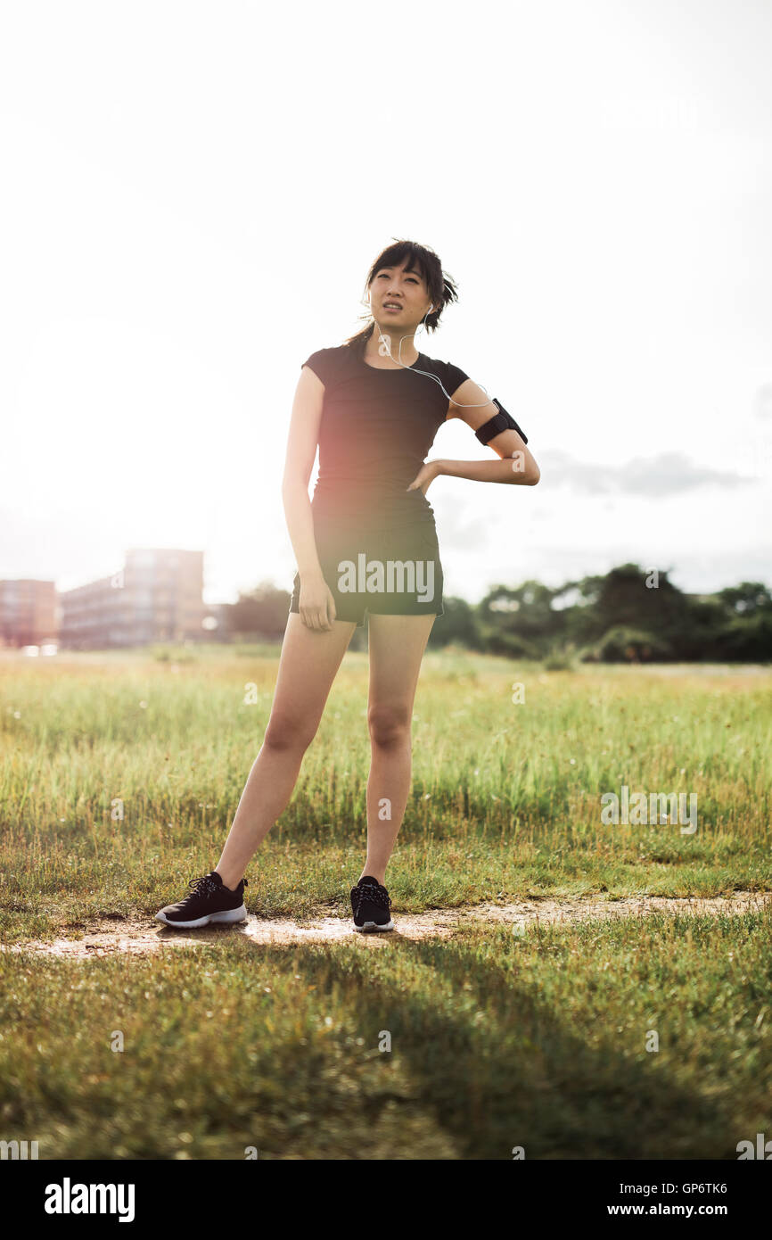Full length portrait of a fit and healthy young woman runner standing ...