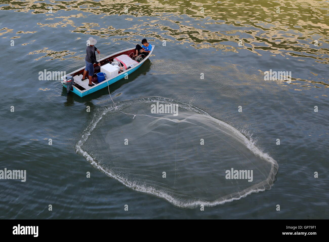 Asian Fisherman fishing in the River Stock Photo - Alamy