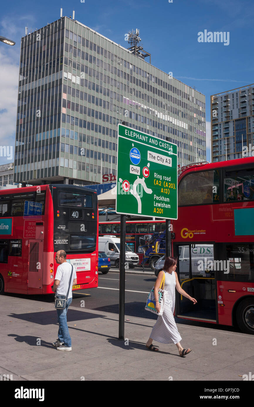 London buses and a traffic sign showing the new road layout at Elephant ...