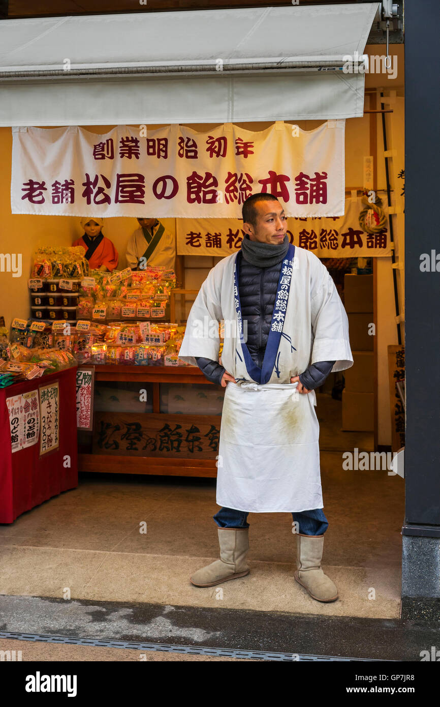 Japanese chief waiting outside bakery shop, kamakura streets, japan ...