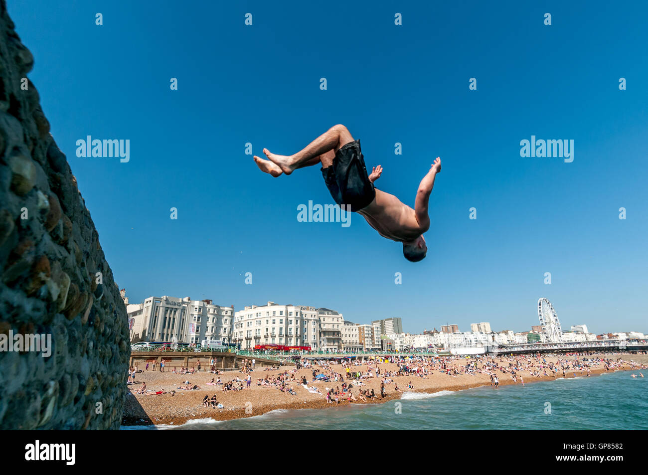 A teenager diving into the sea on Brighton seafront Stock Photo - Alamy