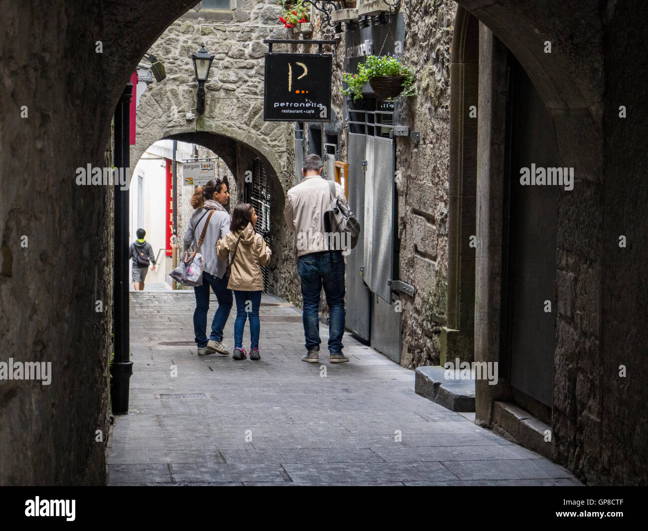 Kilkenny's Butterslip - tourists stop to admire along an alleyway in Ireland's mediaeval city ...