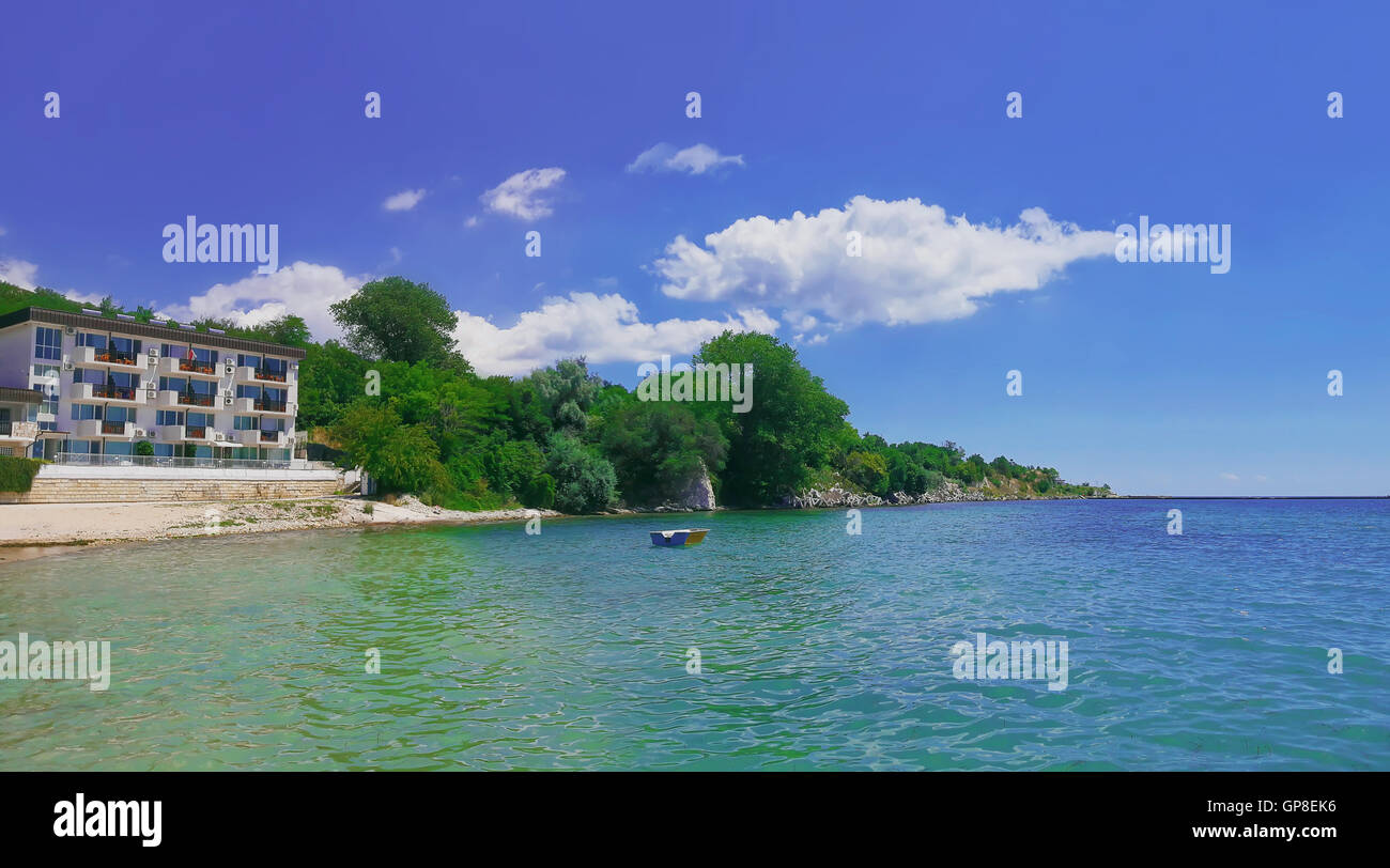 Summer vacation background with a hotel on the seashore. Panoramic view ...