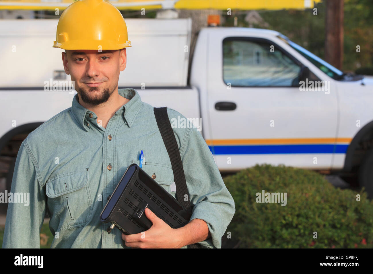 Portrait of lineman with cable box going to the house Stock Photo - Alamy