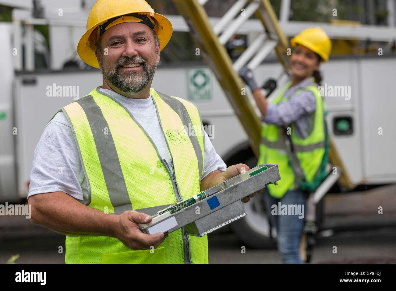 Happy cable lineman with junction box at site Stock Photo - Alamy