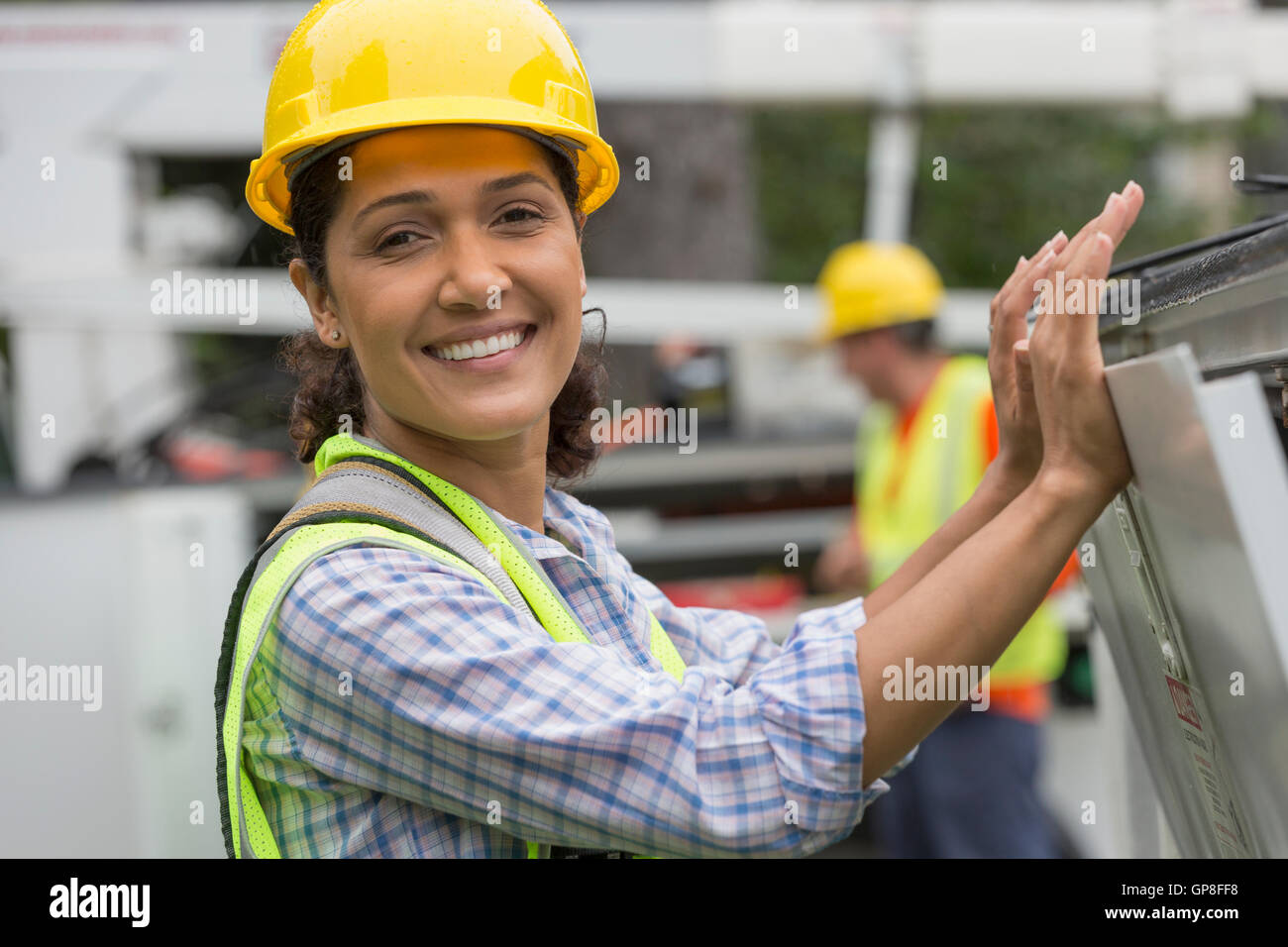 Portrait of happy Hispanic female utility worker smiling at site Stock ...