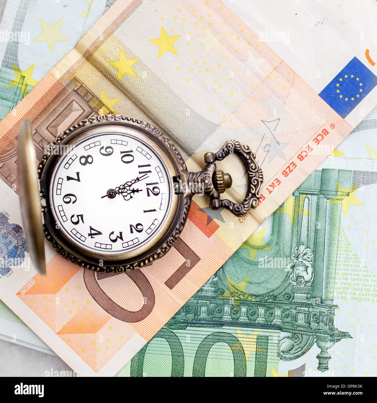 Time is money concept with euro banknotes and pocket watch Stock Photo ...