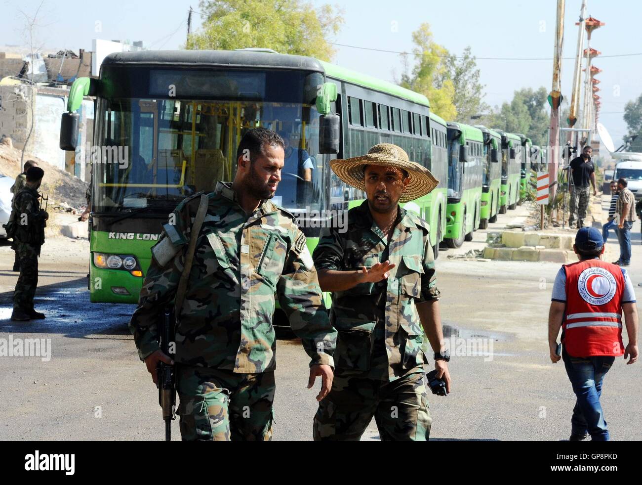Damascus, Syria. 2nd Sep, 2016. Syrian soldiers wait in front of buses ...
