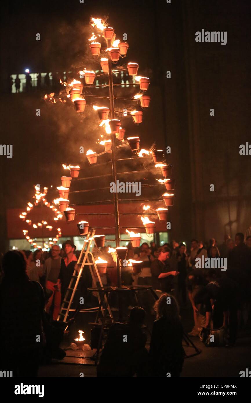 With burning metal structures, cascading candles and flickering ...