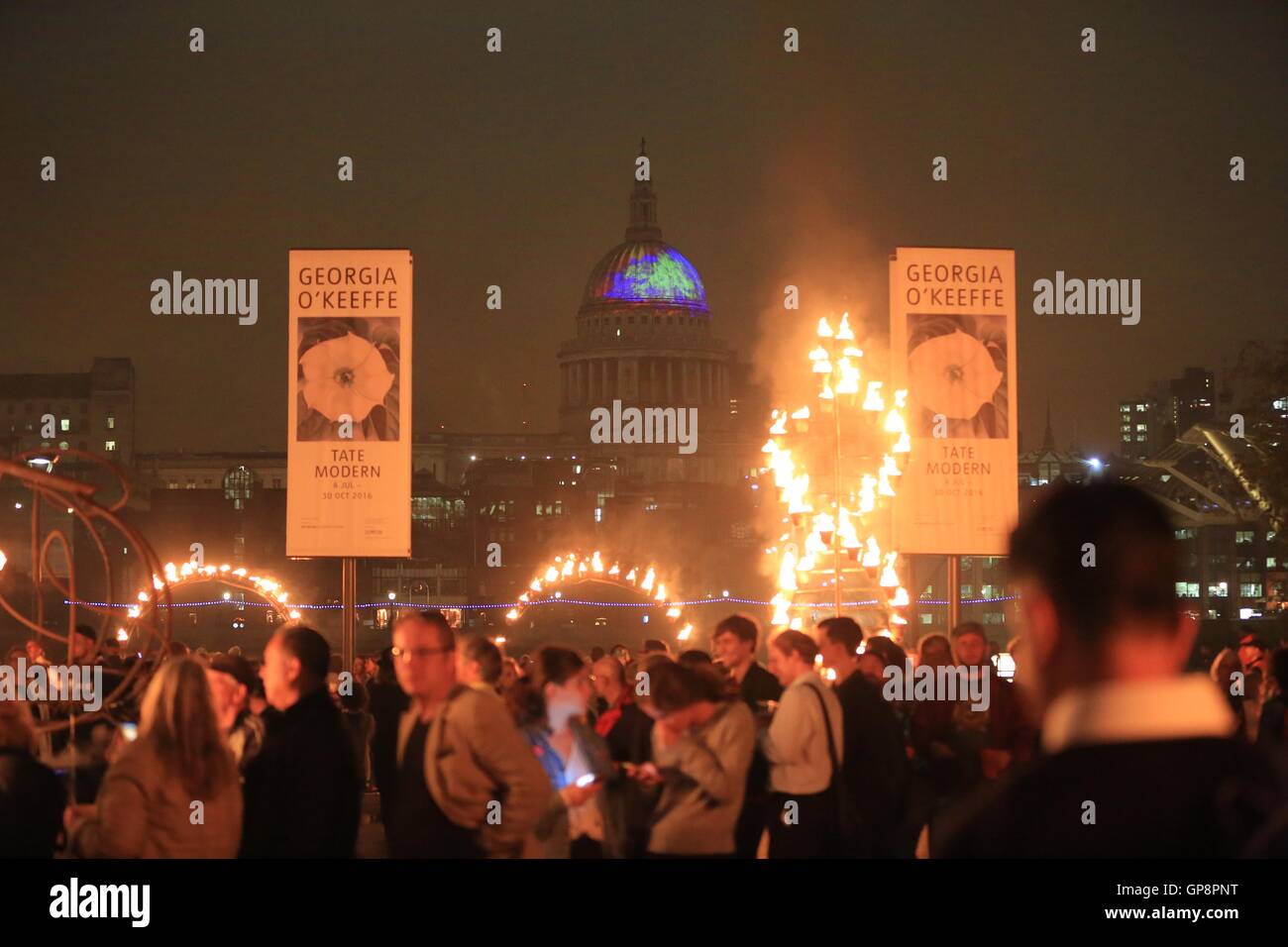 With burning metal structures, cascading candles and flickering ...