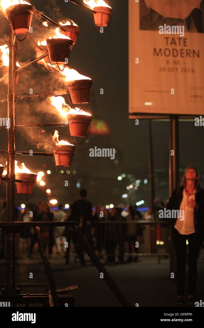 With burning metal structures, cascading candles and flickering ...
