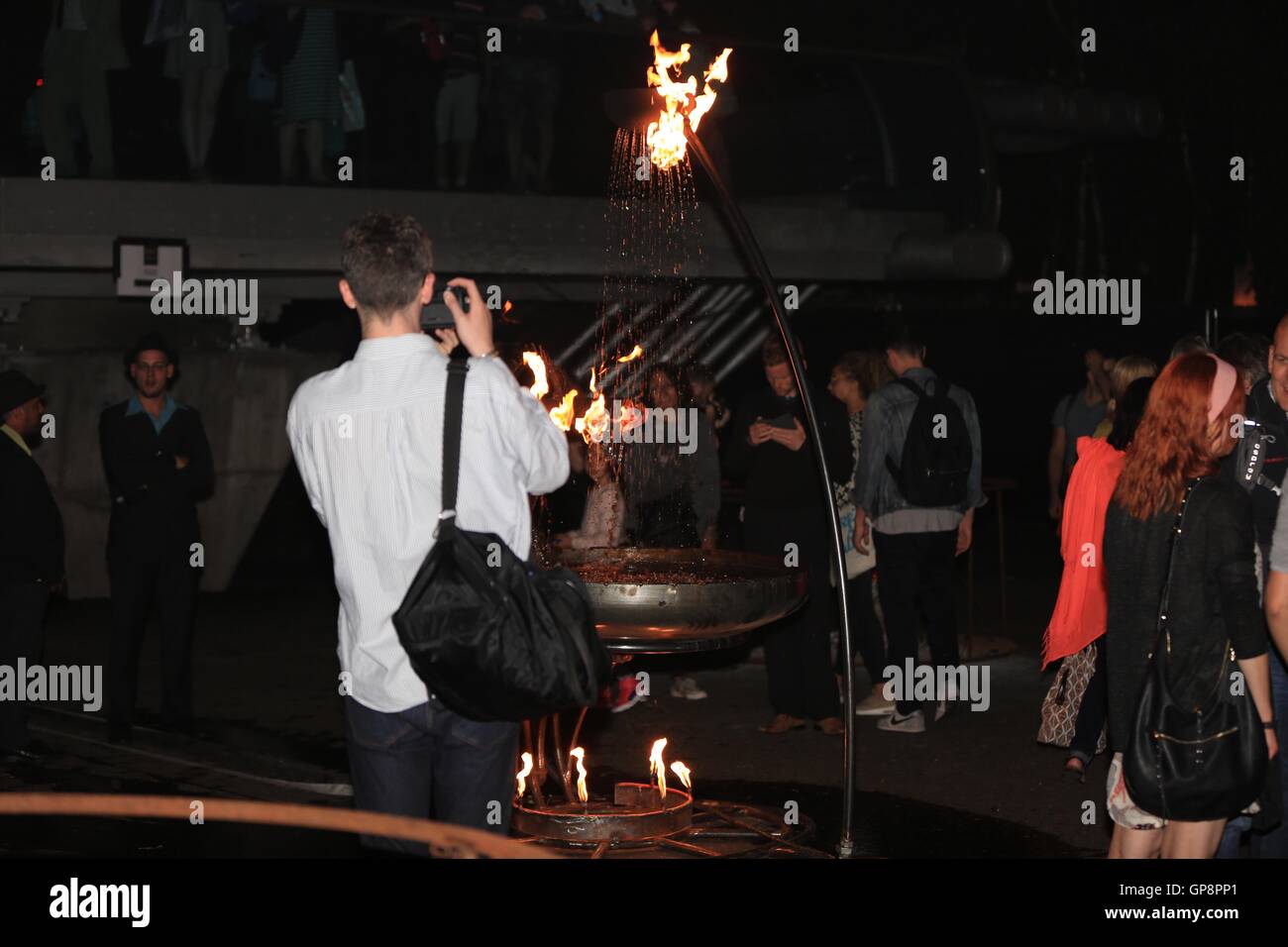 With burning metal structures, cascading candles and flickering ...