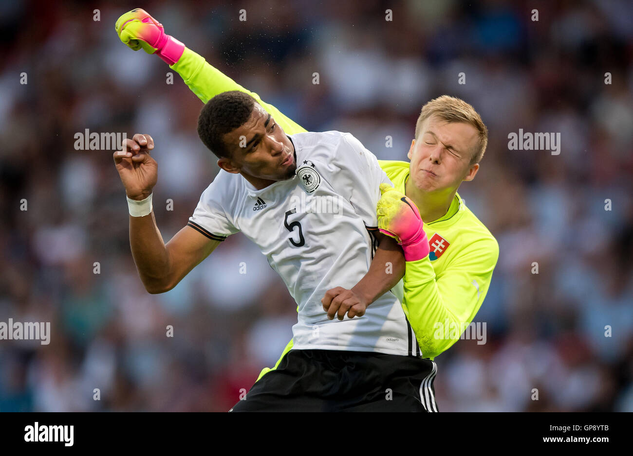 Germany's Kevin Akpoguma and Slovakia goalkeeper Marek Rodak compete ...