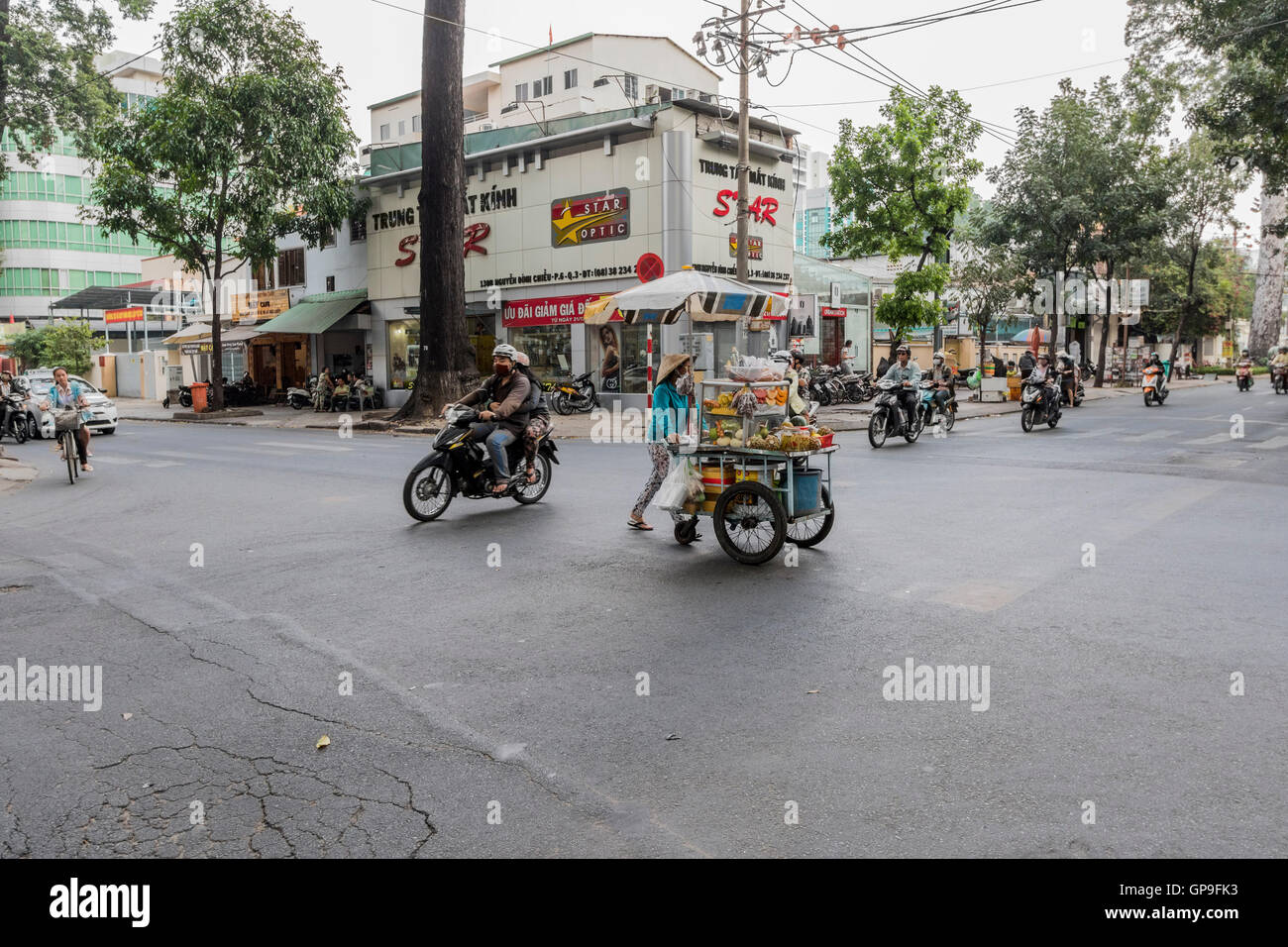 Motorcycles and mobile vendor on road in Ho Chi Minh city Vietnam Stock ...