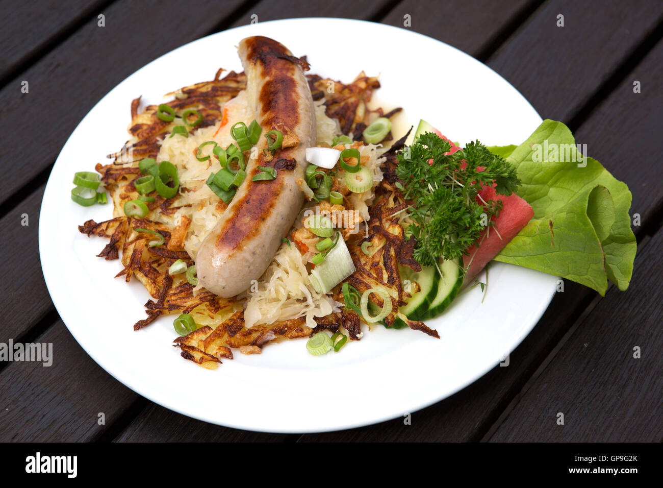Thuringian bratwurst (grilled sausage) served with sauerkraut and salad ...
