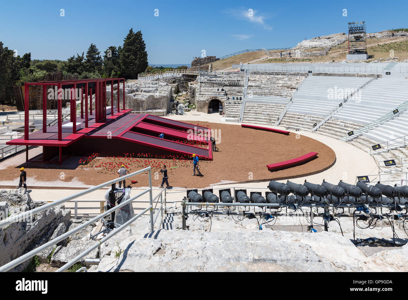 Workers preparing a stage for a performance in the old Greek theatre of ...