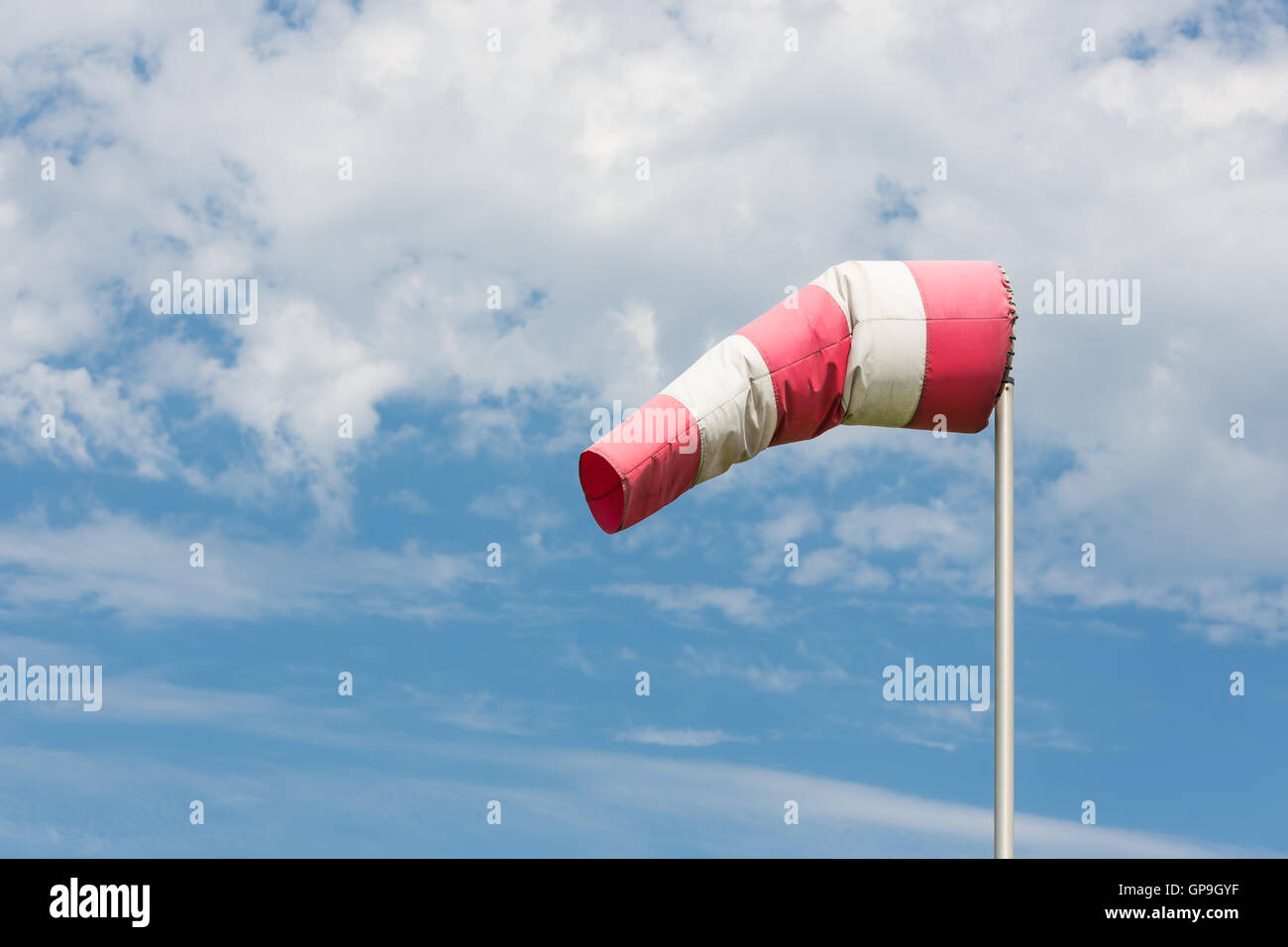 Windsock blowing in the wind against cloudy sky Stock Photo - Alamy