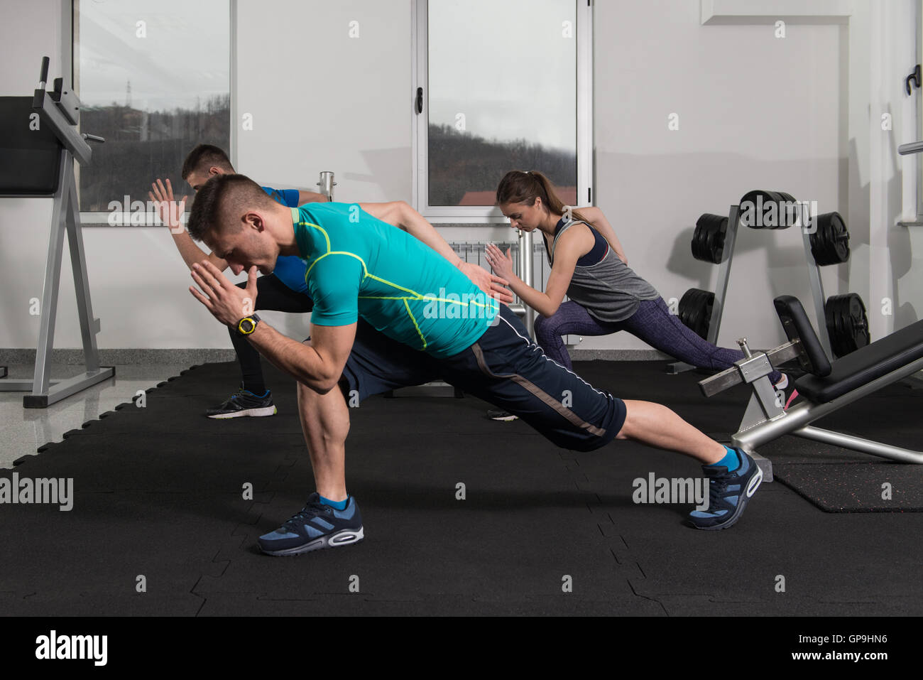 Group Of Athletes Stretching Before Starting A Workout Session Stock ...