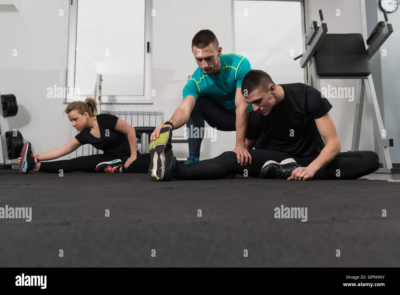 Group Of People At The Gym In A Stretching Class Stock Photo - Alamy