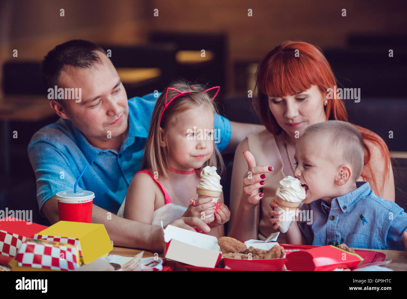 Happy family eating ice cream in restaurant Stock Photo - Alamy