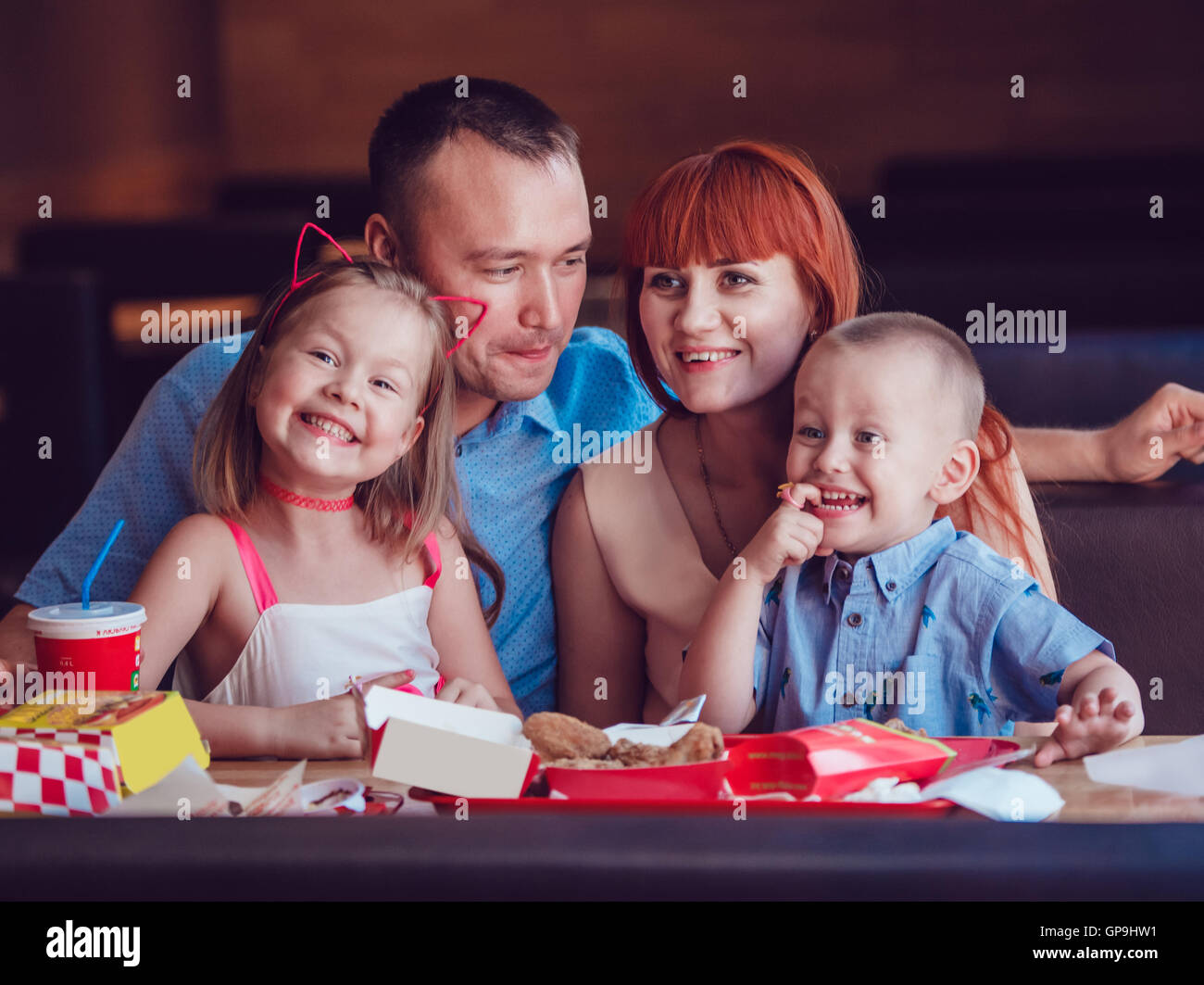 Happy family eating fast food in restaurant all together Stock Photo ...