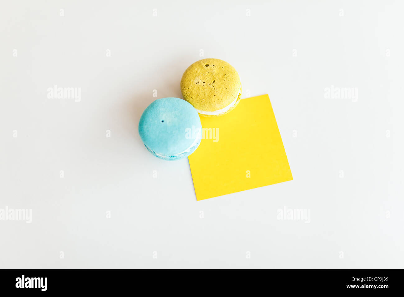 French macaroons and yellow sticker on a white background Stock Photo ...