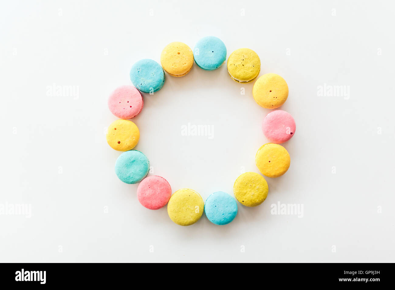 French macaroons laid out in a circle shape on white background Stock ...