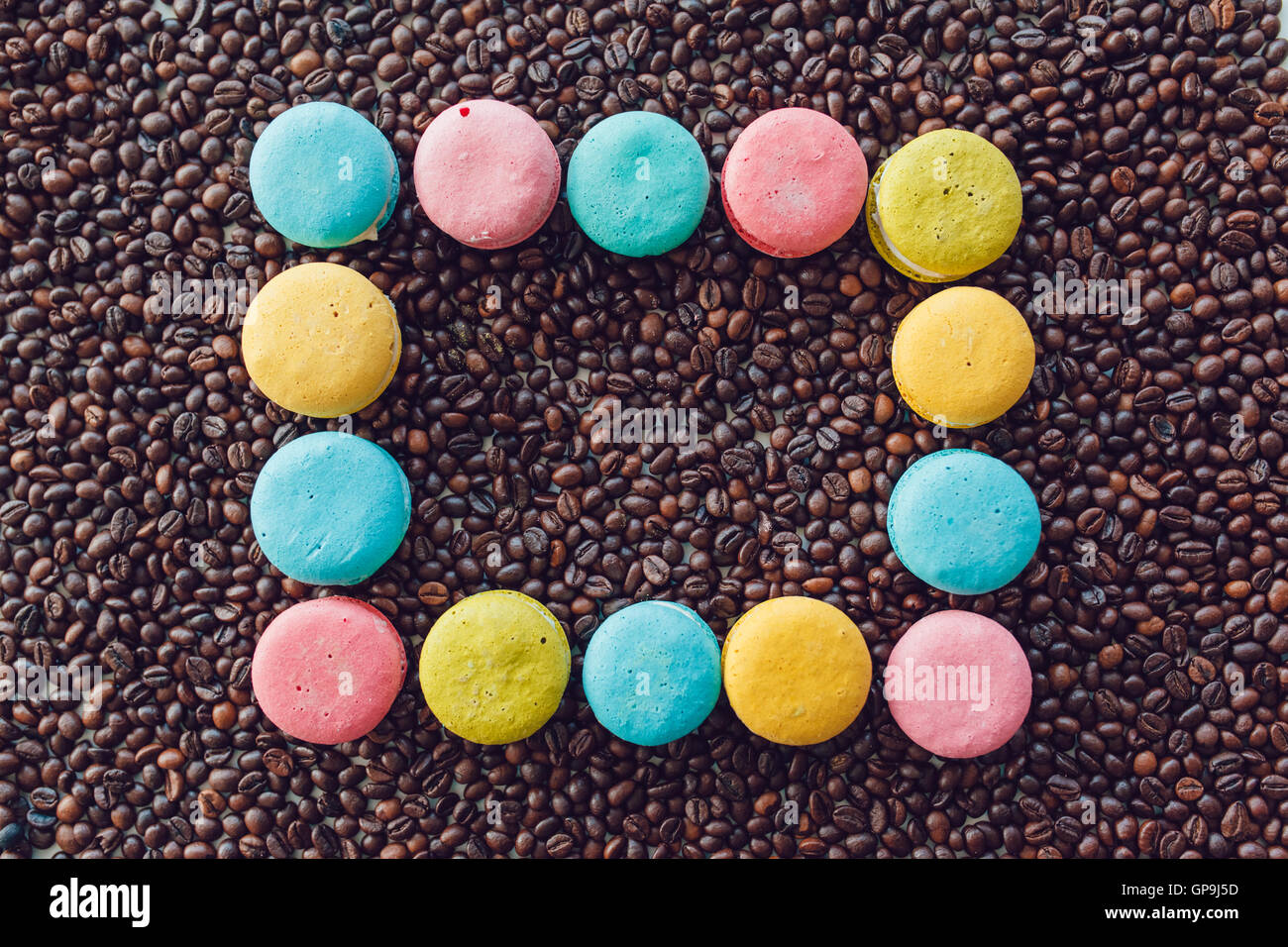 French macaroons laid out in a square on coffee beans background Stock ...