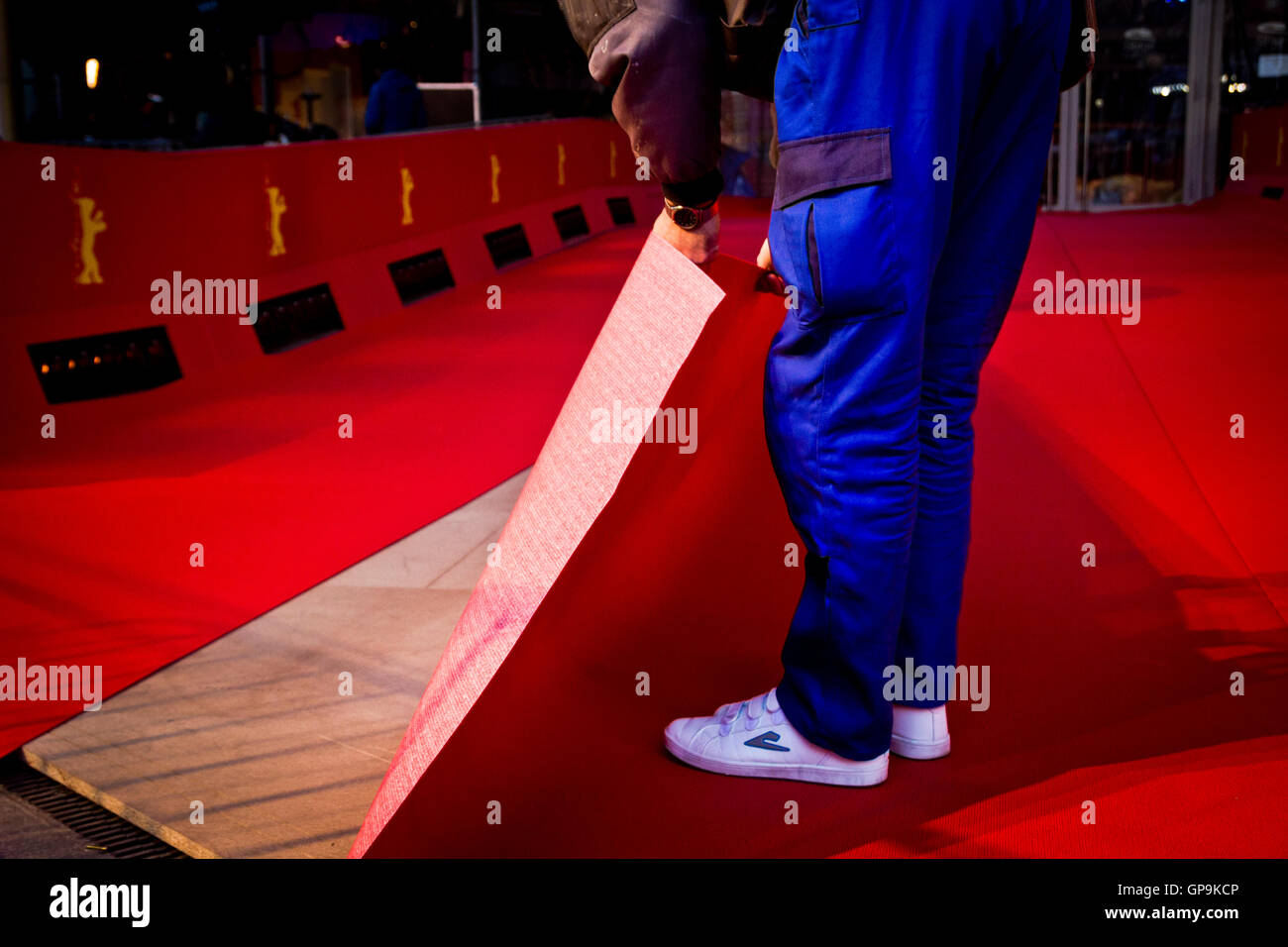 Workers unrolling the red carpet outside the Potsdamer Platz Theatre in ...