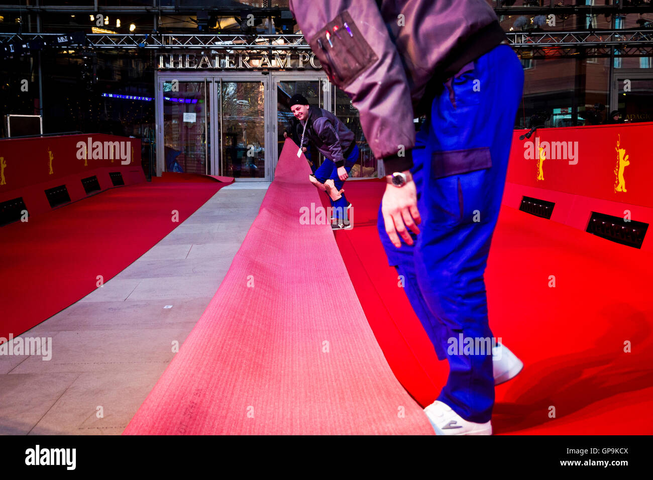 Workers unrolling the red carpet outside the Potsdamer Platz Theatre in ...