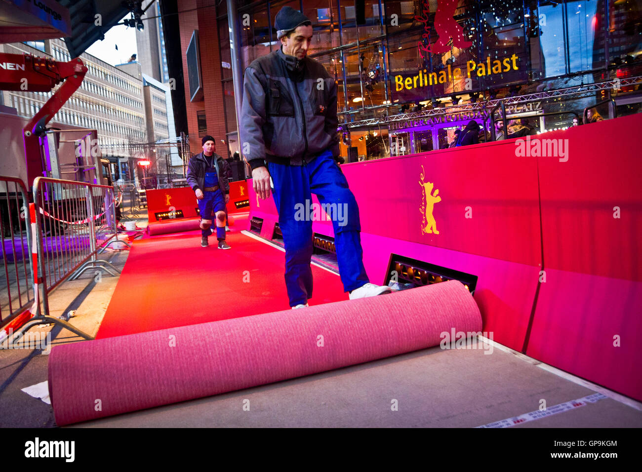 Workers unrolling the red carpet outside the Potsdamer Platz Theatre in ...
