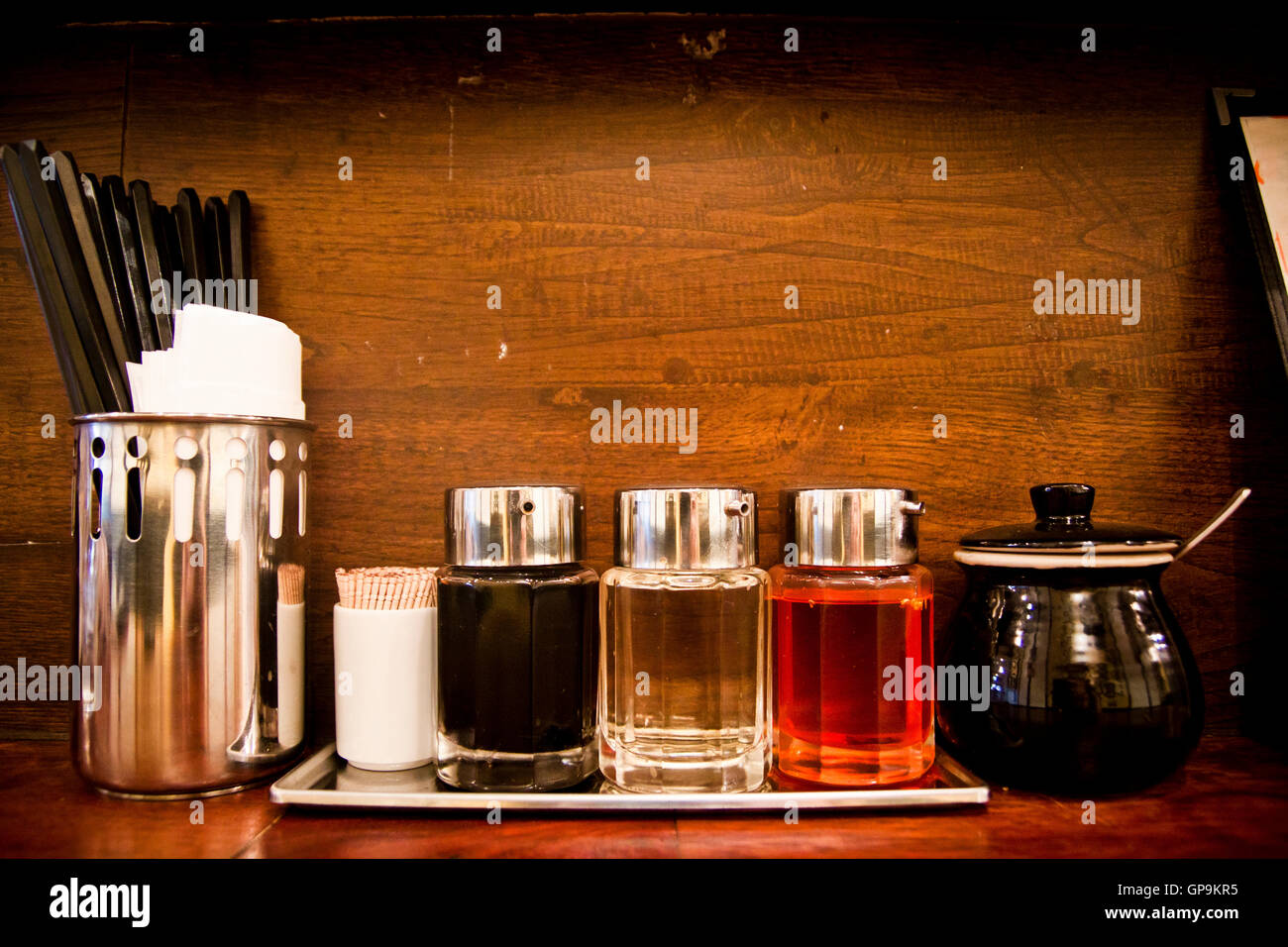 Condiments lined up on the counter of a noodle restaurant in Tokyo ...