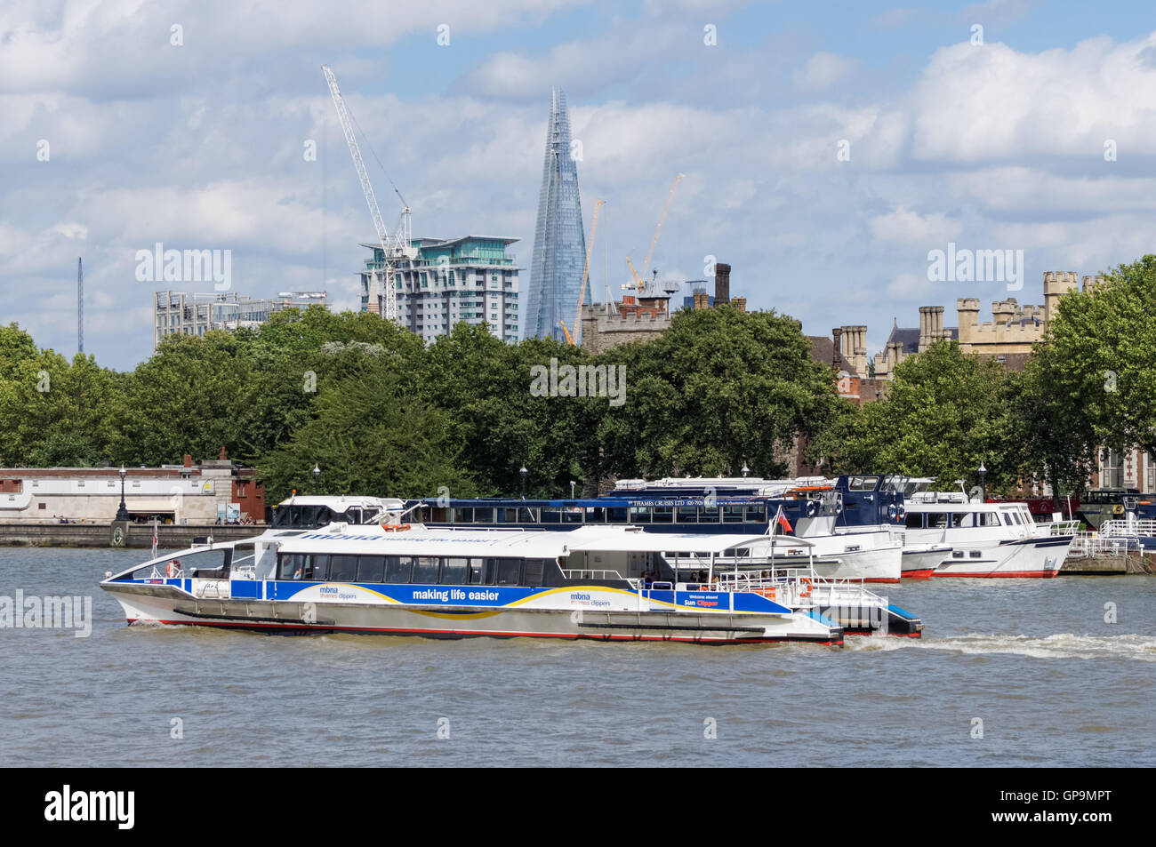 Thames clipper on the River Thames with Shard skyscraper in the ...