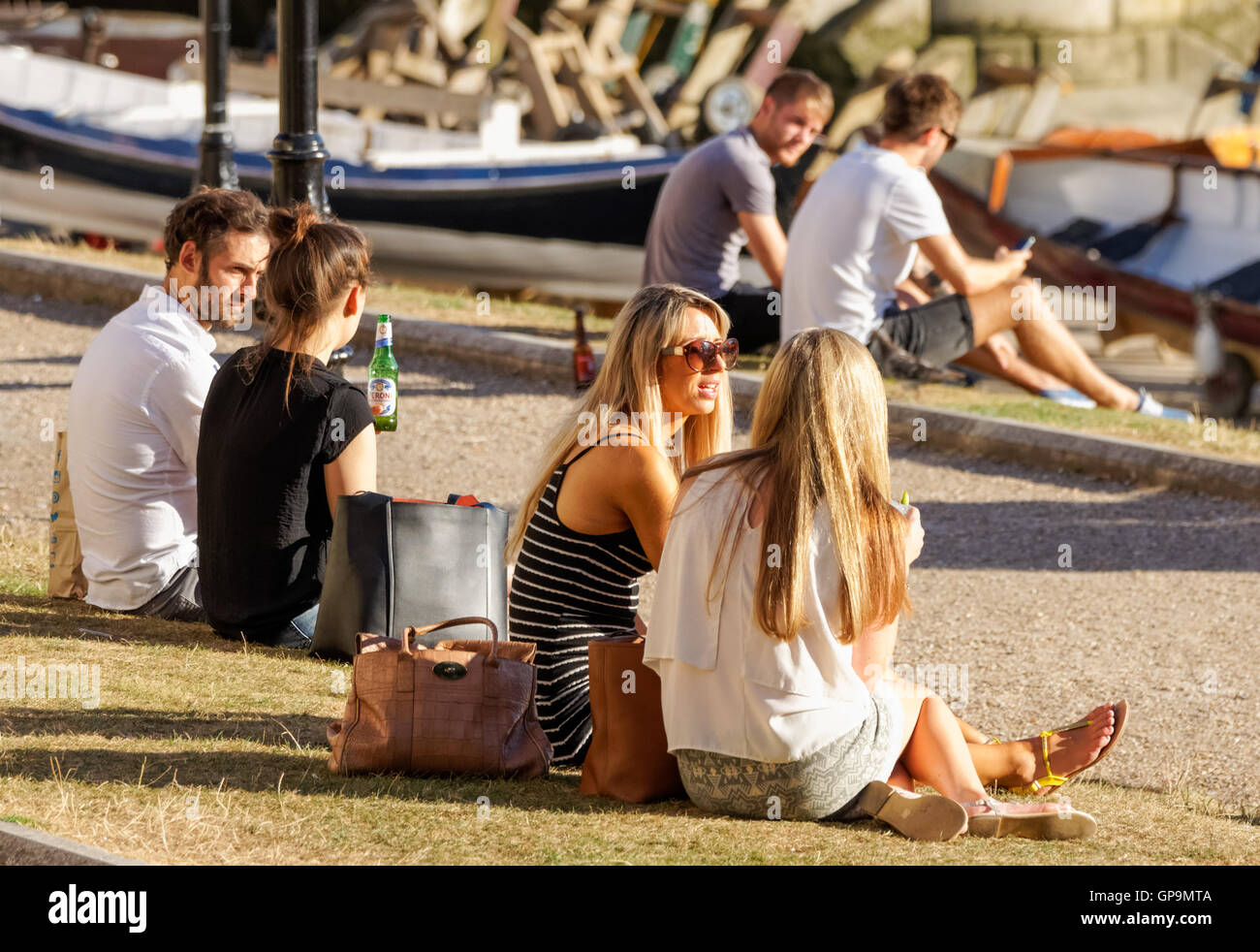 Young women sitting riverside hi-res stock photography and images - Alamy