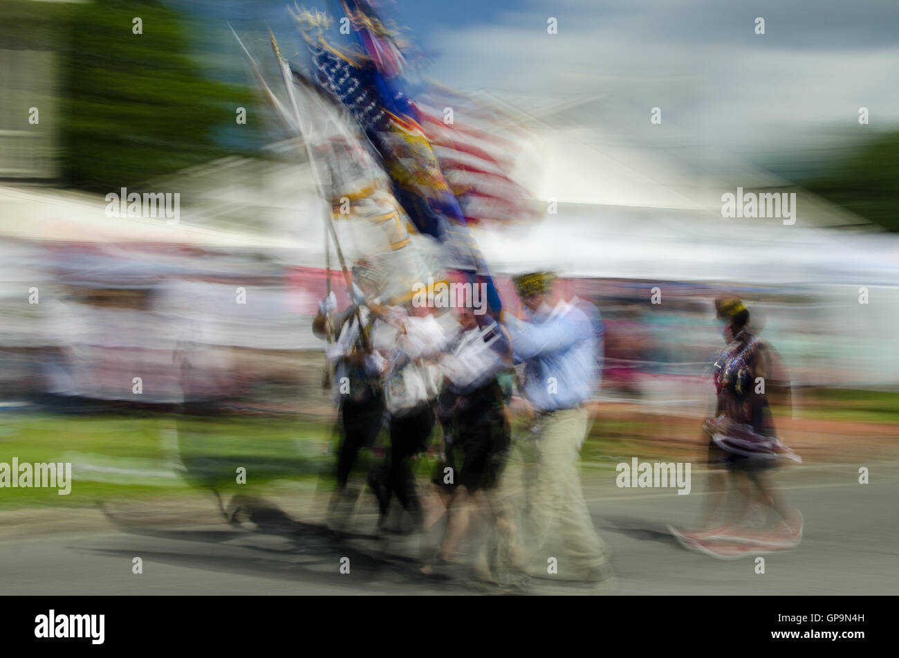 A group of veterans carrying flags marching at a local independence day ...